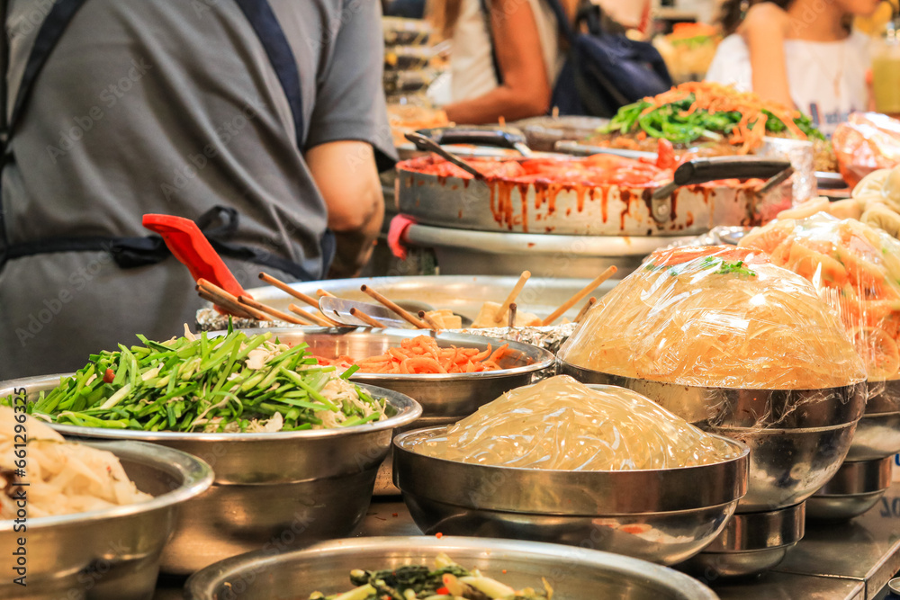 Tteokbokki, kimbap, japchae, famous street food closeup at Gwangjang Market, one of the most ...