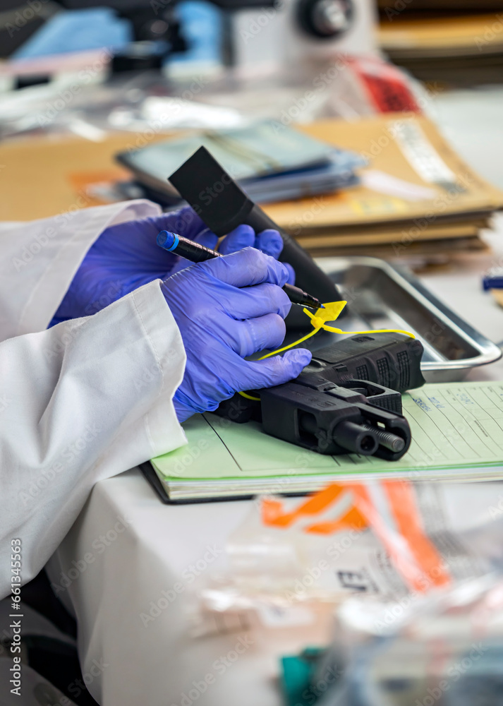 Police scientist writes serial number on firearm magazine in crime lab ...