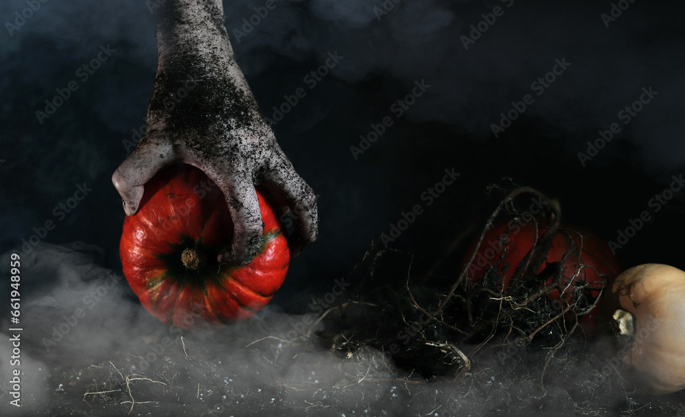 Zombie hand holding a pumpkin. A corpse's hand, plant roots and various ...