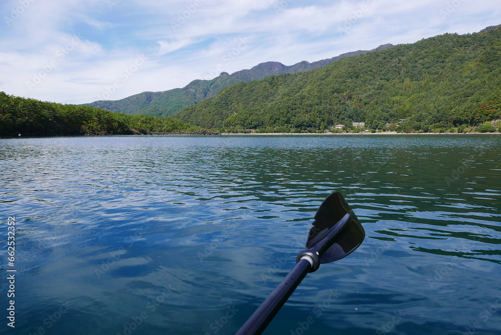 Kayak and canoe at Lake Saiko near Mt. Fuji. The calm water surface is ...