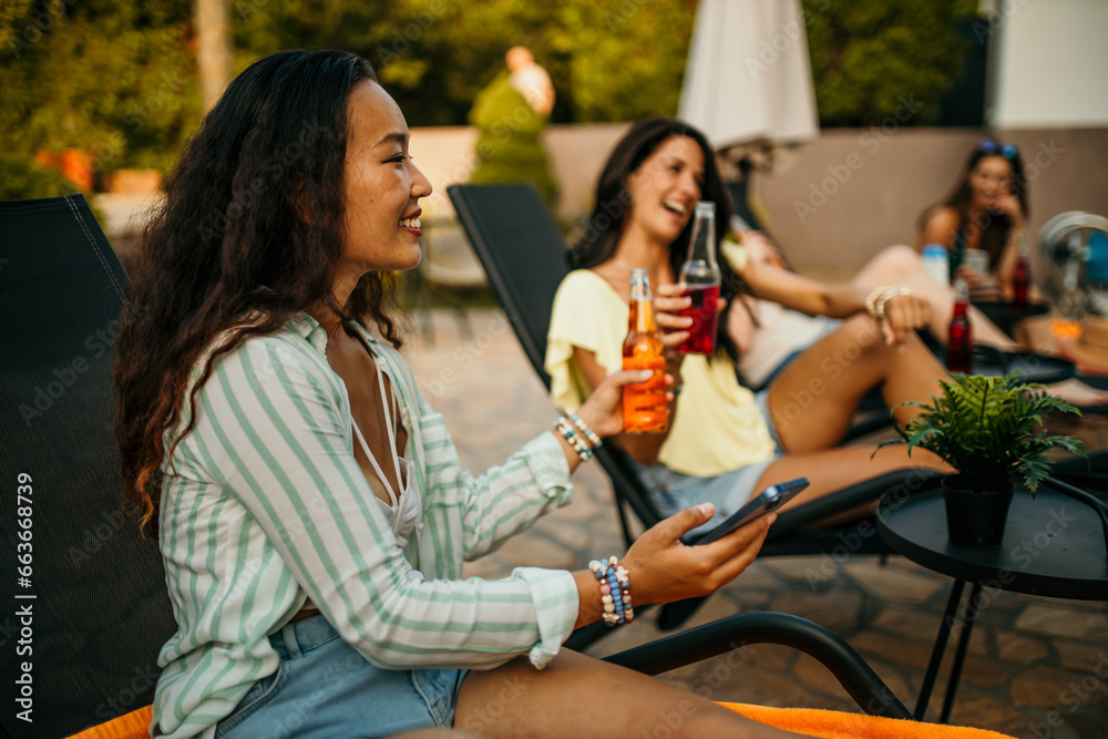 An Asian woman with a bunch of friends having a blast at a poolside ...