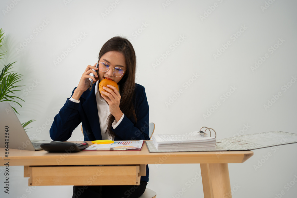 Busy and tired businesswoman eating Bread and milk for lunch at the ...