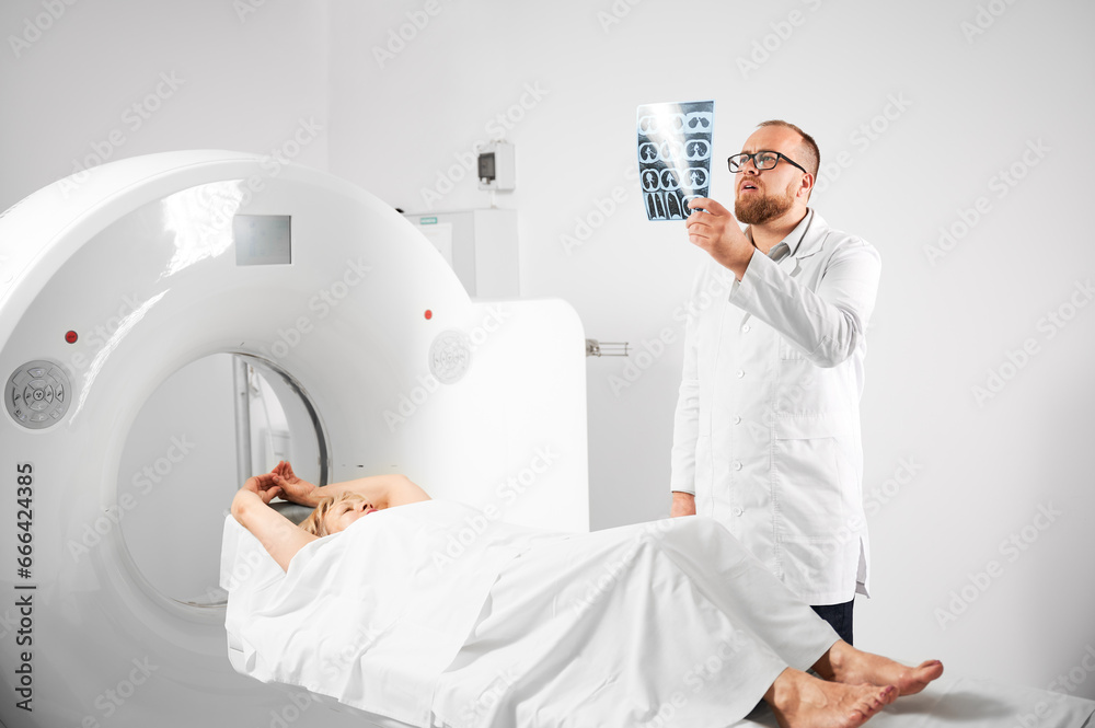 Medical computed tomography or MRI scanner. Doctor holding and ...