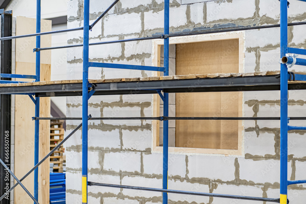 Construction scaffolding. Stone wall with window. Construction ...
