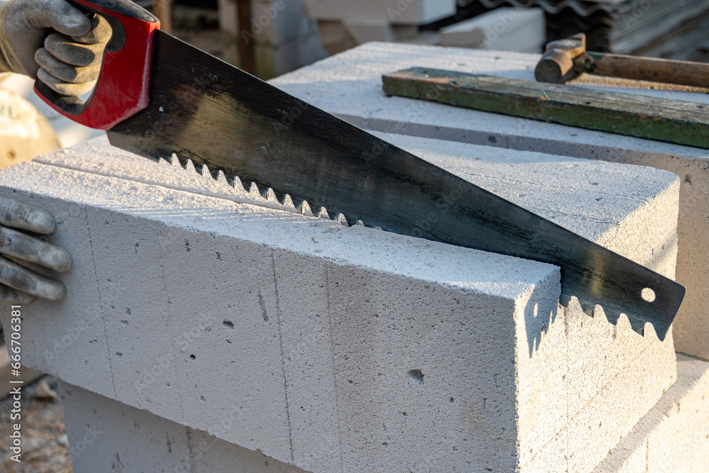 Preparation of aerated concrete block. Sawing a gas block. Construction ...