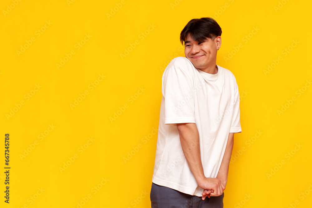 modest young asian guy in a white t-shirt is shy and embarrassed on a ...