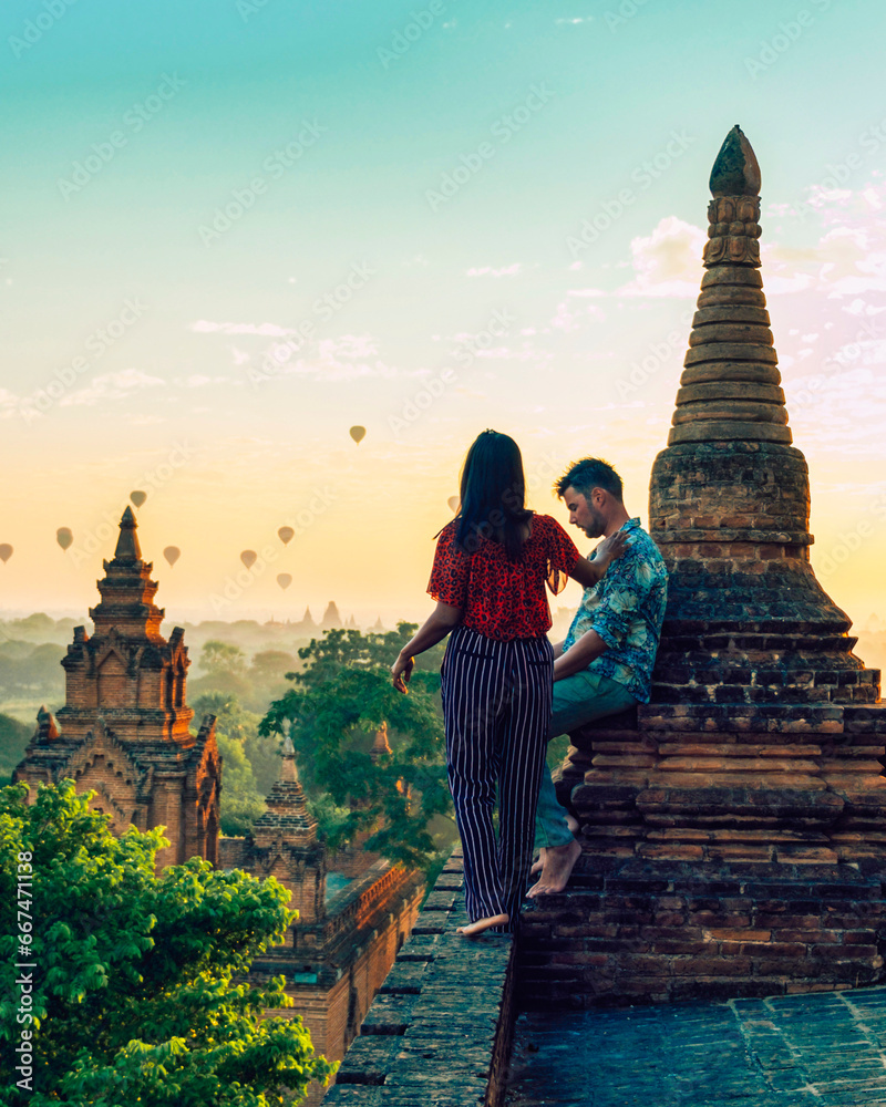 a couple visit Bagan Myanmar, Sunrise above temples and pagodas of ...