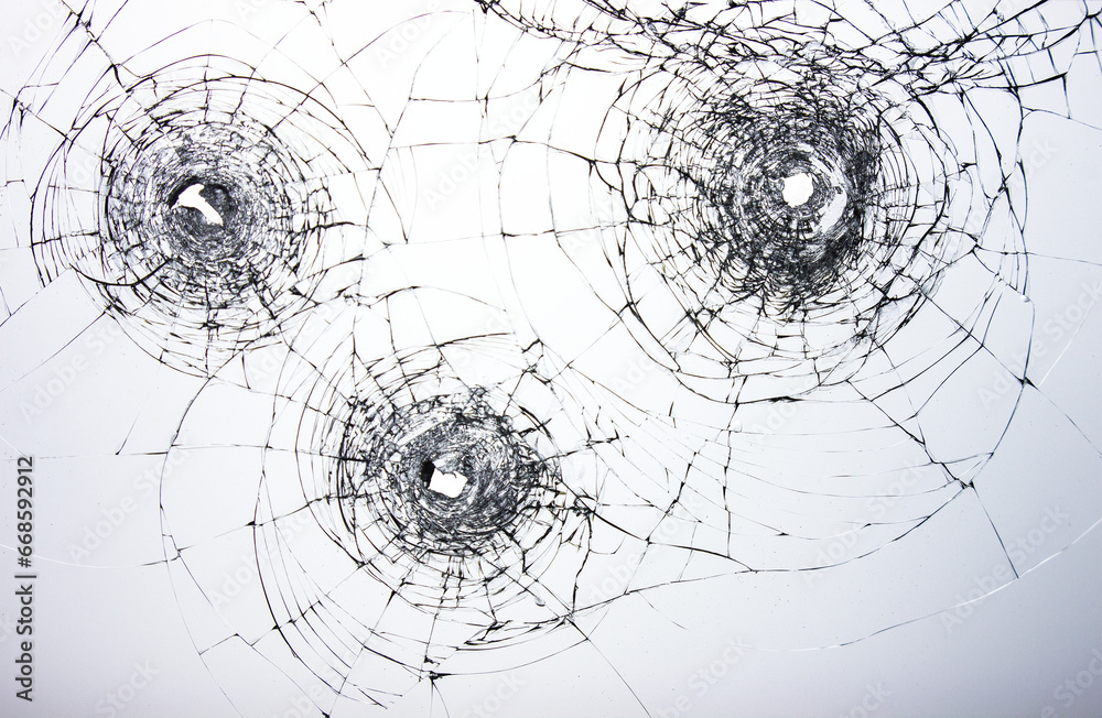 Holes with cracks in the glass. Bullet shots into the windshield of the ...