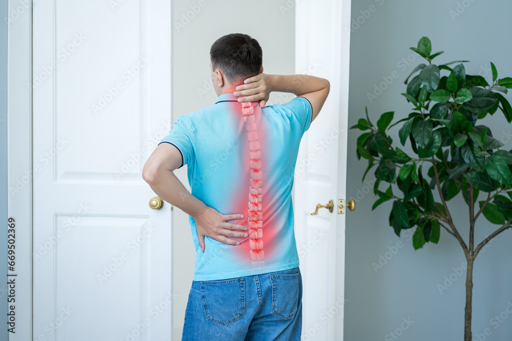 Lumbar and cervical spine hernia, man with back pain at home ...