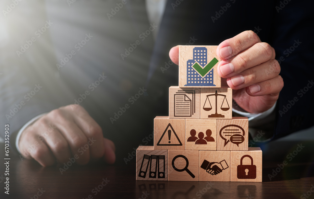 Building corporate governance structure. Businessman stacking wooden ...