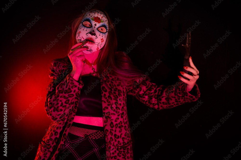 A fashion-forward woman with masquerade mask poses in a leopard print ...