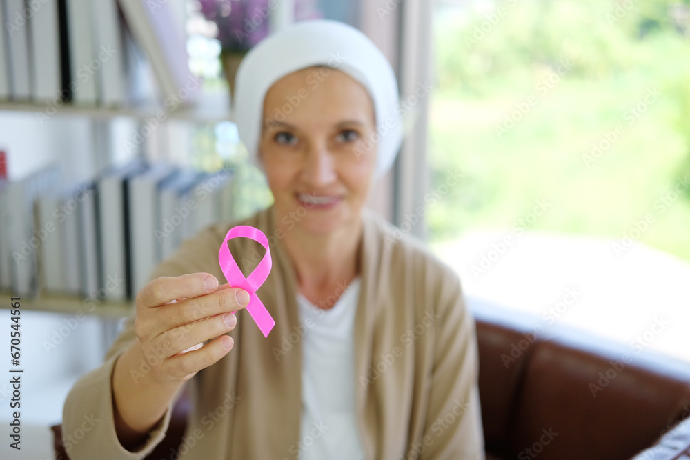 Closed up Awareness pink ribbon on Caucasian elderly senior woman hands ...