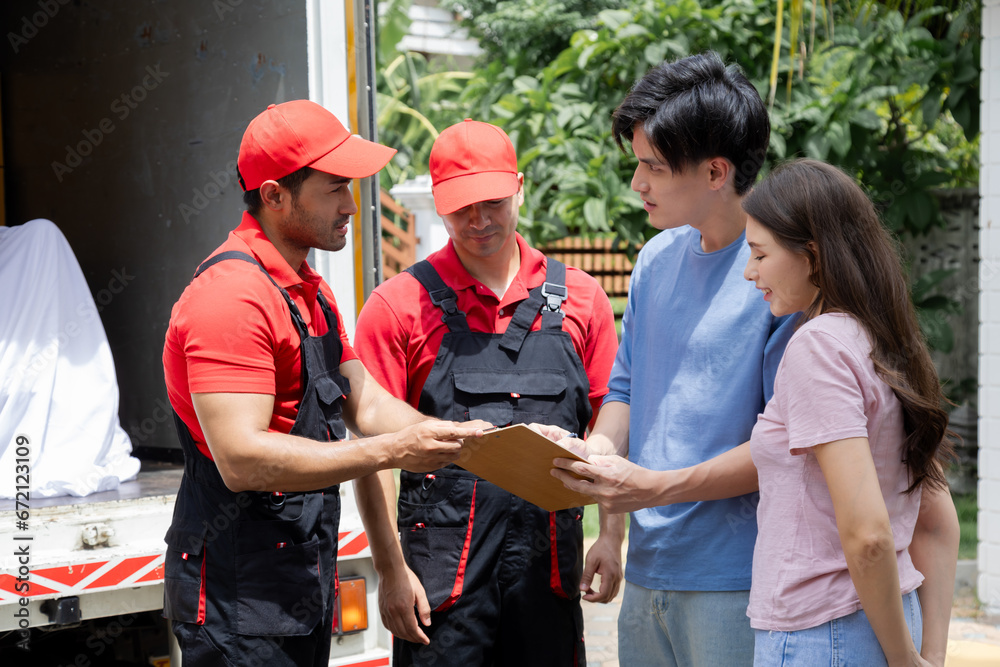 Newlywed couples using professional moving house services sign contract or receive furnitures ...