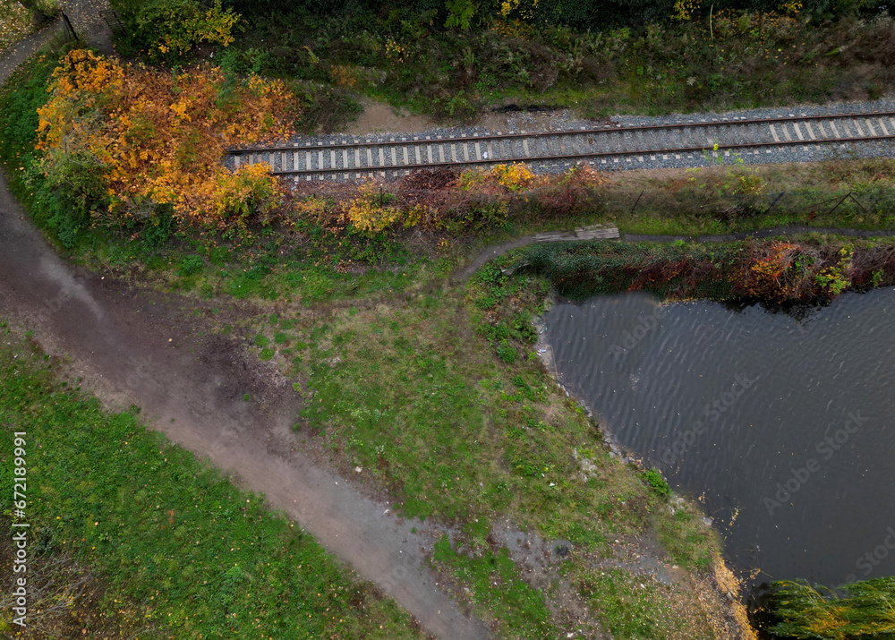 fly over railroad tracks in the countryside. vertical view of the ...