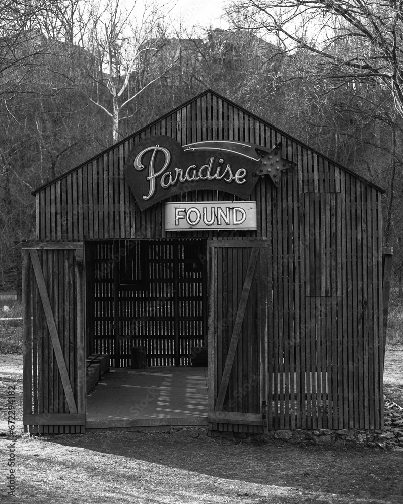 Rustic wooden shack, featuring a side view with an open door and the ...