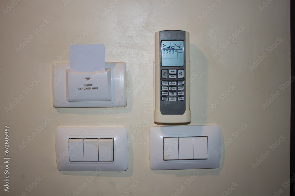 Key Card insert in key card holder in hotel room with air conditioner ...