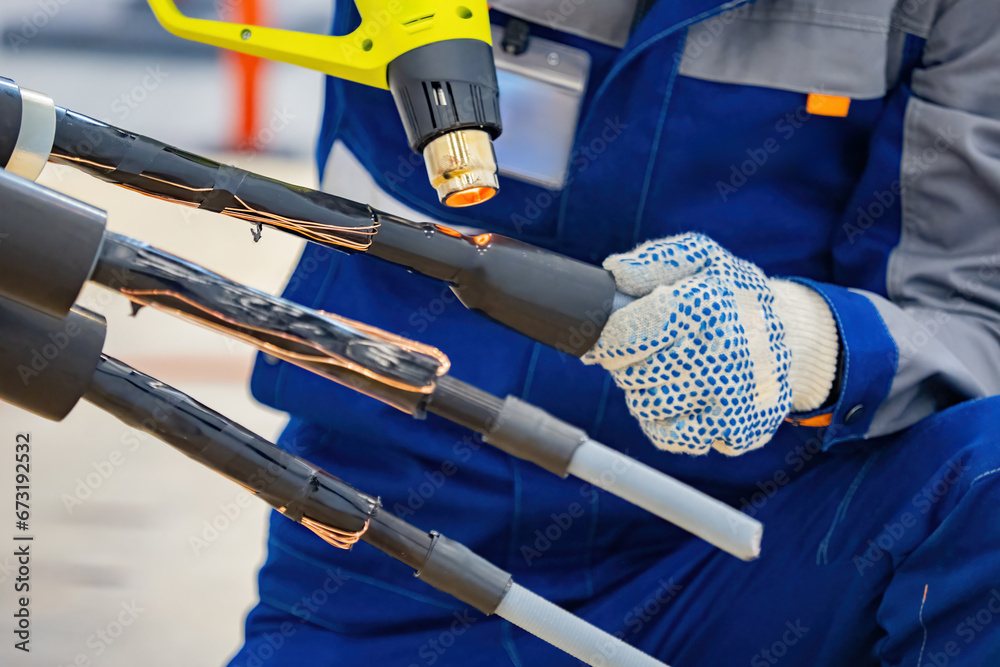 Hands of electrician with voltage wire. Cable joining. Installation ...