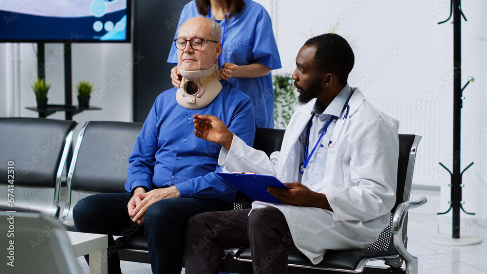Traumatology team removing cervical collar off of asian patient with ...