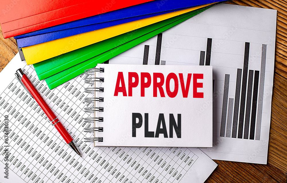 APPROVE PLAN text on a notebook with pen, folder on a chart background ...