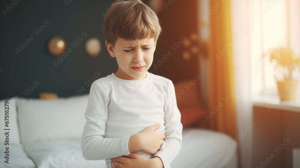 sad little boy holding his stomach, illness, cramps, health, color ...