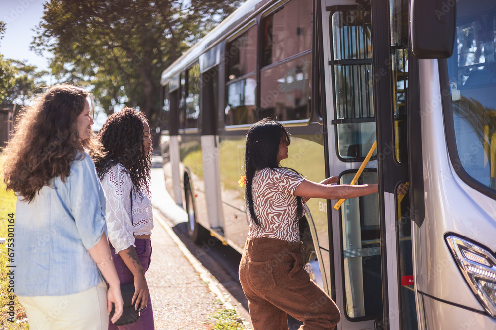 Multiracial group of women getting on the bus. Stock Photo | Adobe Stock