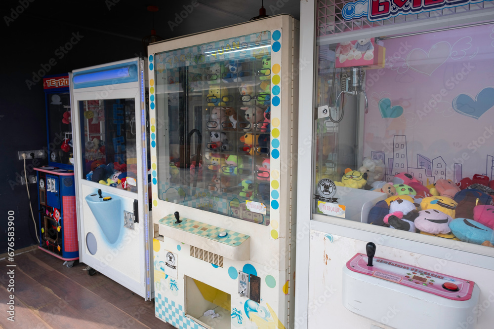 Arcade Claw Machines with Stuffed Toys. Rows of Claw Crane Games at an ...