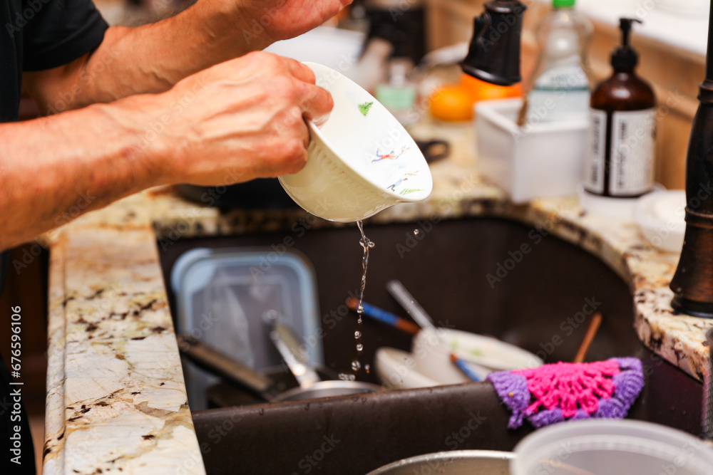 hand-washing dishes, symbolizing equality and shared responsibilities ...