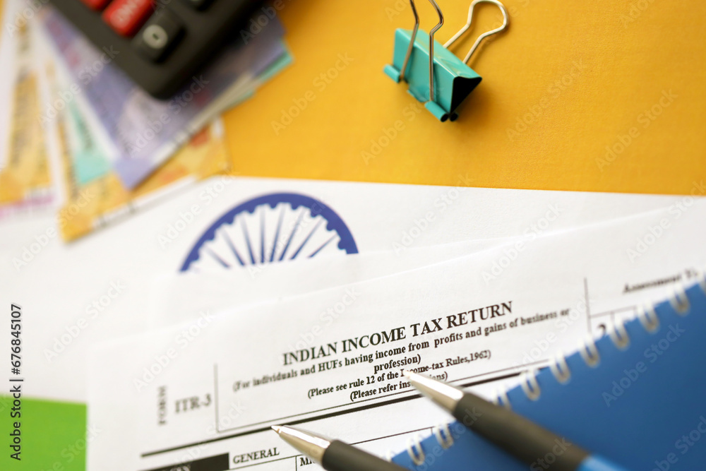 Indian income tax return blank form with pen and indian rupees bills on ...