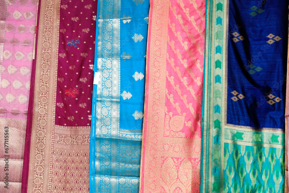 Fancy Indian sarees, Neatly stacked colorful silk saris in racks in a ...