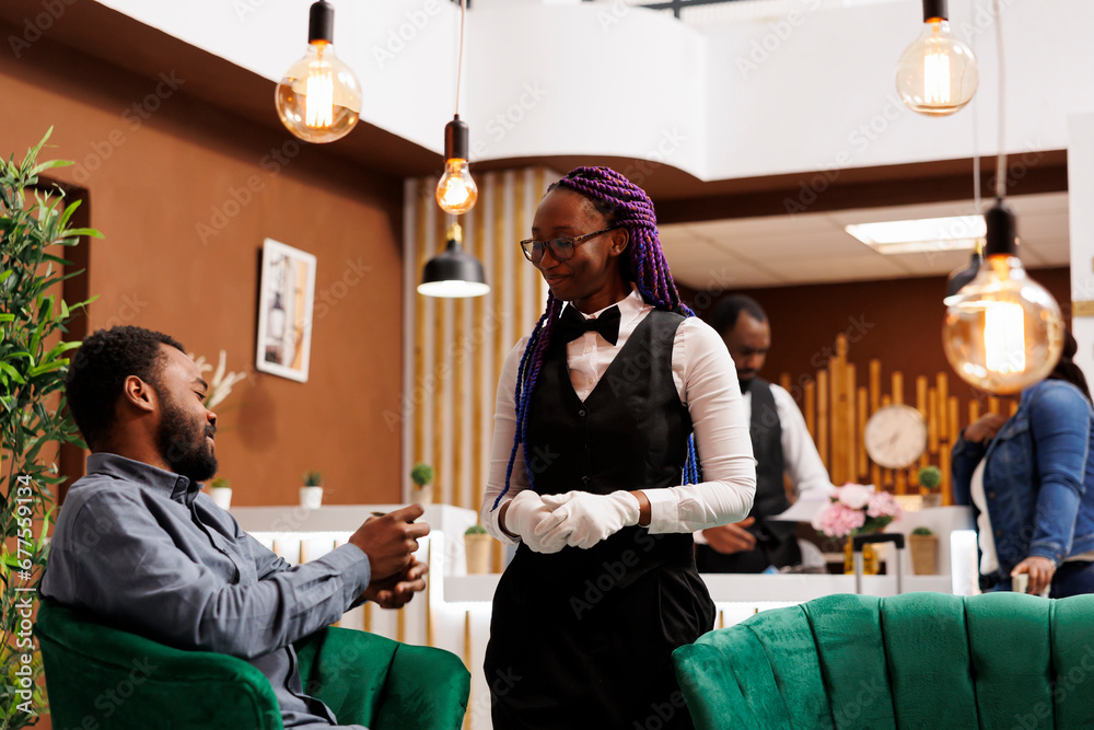 Smiling friendly African American woman hotel employee in uniform ...