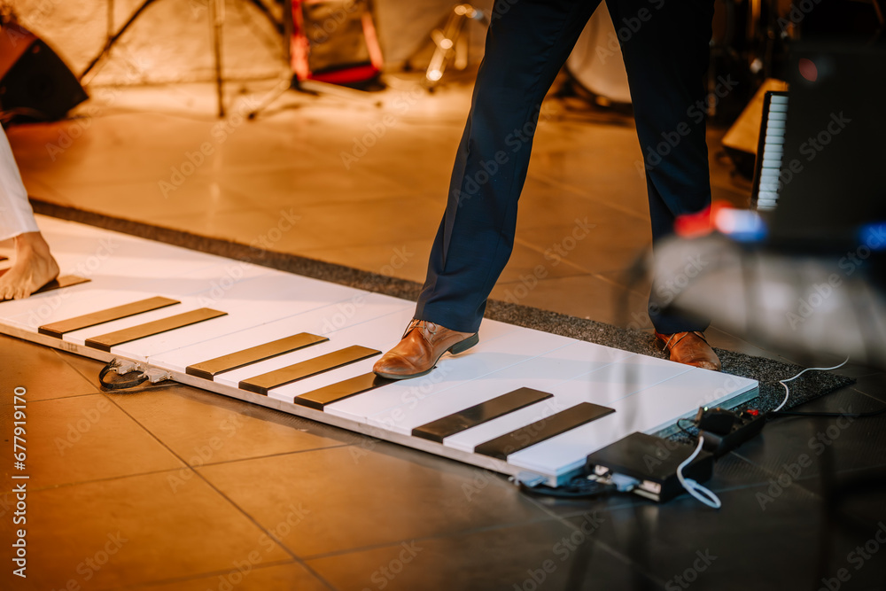 The Famous Big Pian. Popular Grand Floor Keyboard. People playing close ...