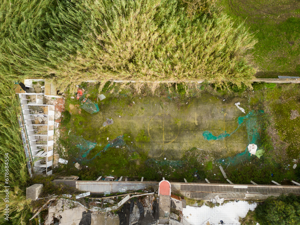 abandoned football field with faded center field seen from above ...