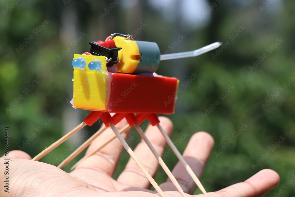 Toy robot working model built for science project holding in hand. STEM ...