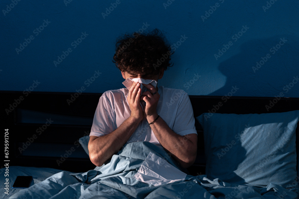 Muslim man suffering cold and flu trying to sleep. Young sick ill ...