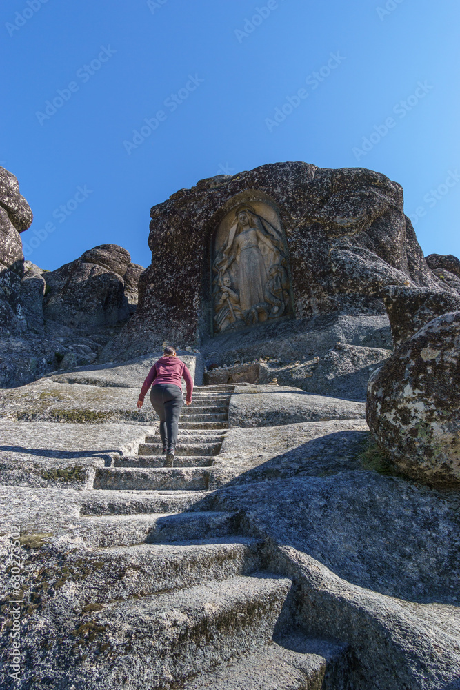Hiking woman on path with stairs to sculpture of Saint Maria Senhora da ...