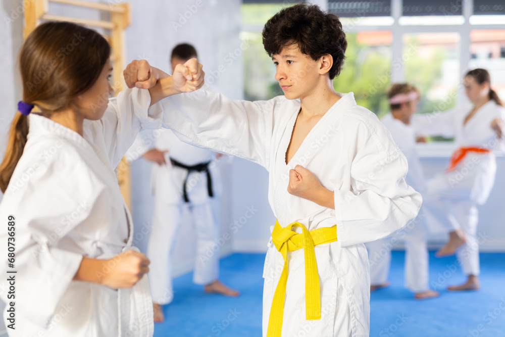 Child boys and girls partners during martial arts karate class train to ...