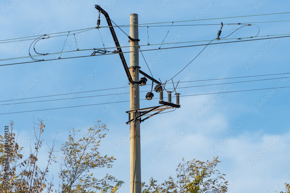 Electrified railway pole on blue sky background. Electric power supply ...
