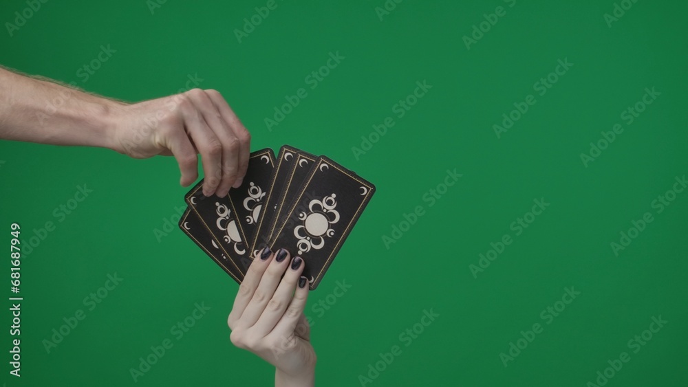 In a frame on a green background. A womans hand that holds a fan of ...