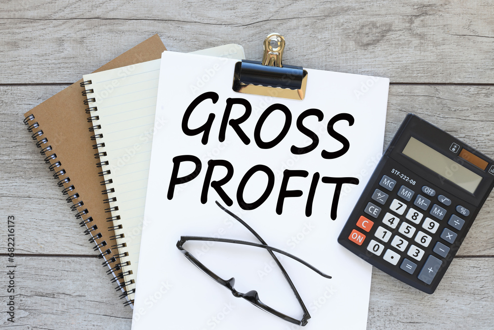 GROSS PROFIT white paper with text. plants in a pot. and pen and ...