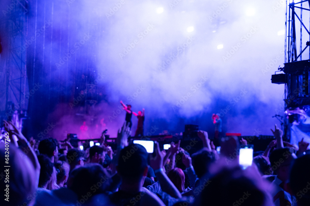 Large indoor concert. Audience partying and dancing. Cheering for ...