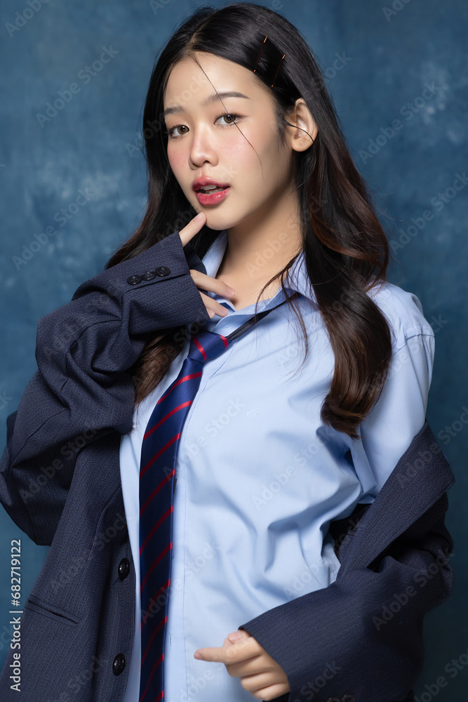 Beautiful Asian woman in school uniform taking a photo of yearbook ...