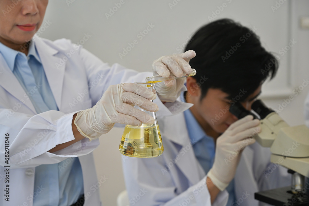 Close-up image of Senior Laboratory instructor woman mixes substances ...