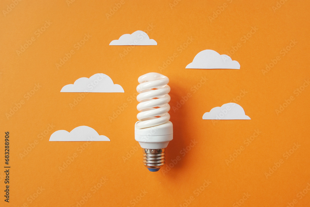 Light bulb with white cut out clouds on orange background. Idea concept ...