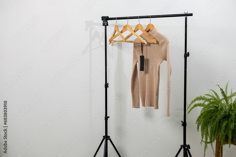 Row of empty hangers on the rack. Wooden coat hanger with blank tag ...