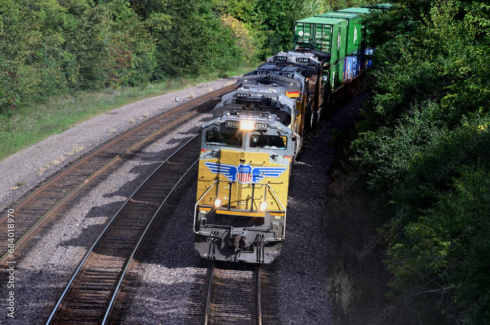 A westbound Union Pacific intermodal freight train transitioning a ...