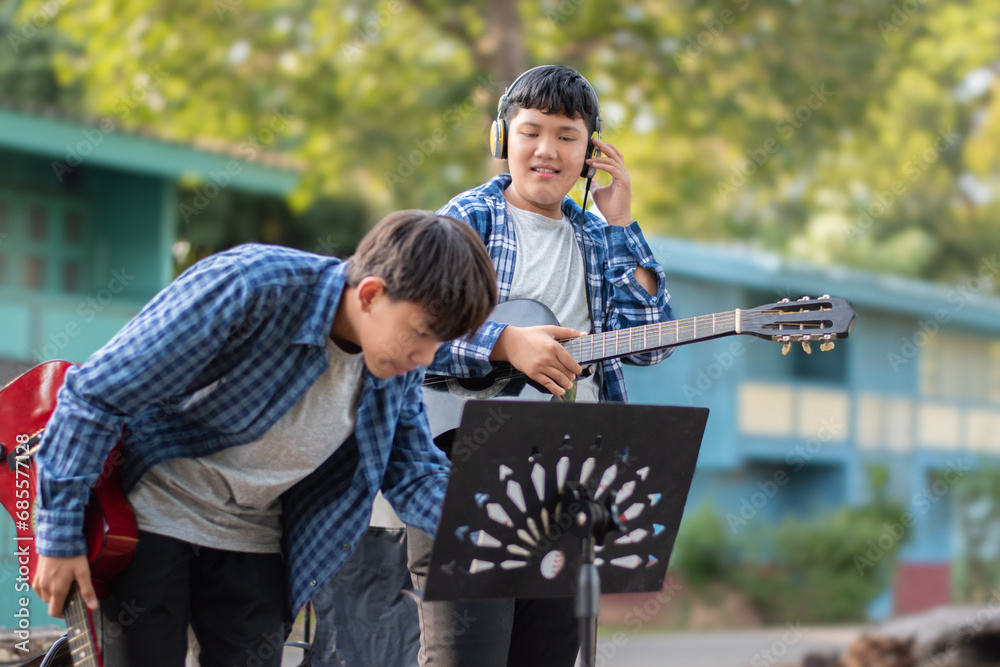 Asian cute boys doing summer activity at their front yard by playing ...