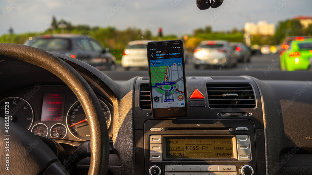 Smartphone showing Waze maps to show the way thru the city Stock Photo ...