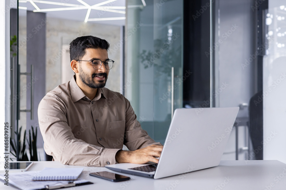 Businessman happy successful and smiling working with laptop inside ...
