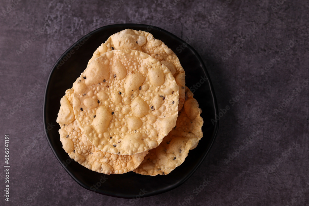 Papadam a traditional indian snack. papad or papadum in raw dried form ...