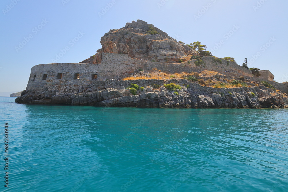 Spinalonga Island on a Beautiful sunny day showing the turqoius sea and ...